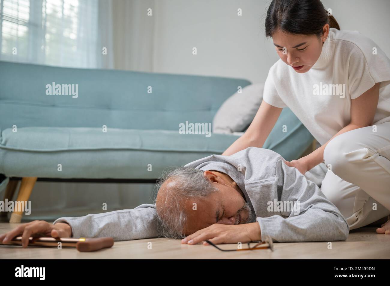 Asia young woman halping her father after falling down on floor Stock ...