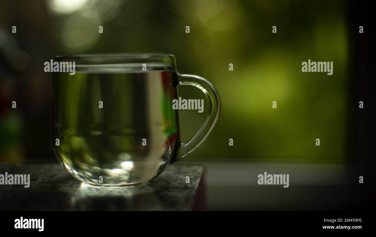 Glass with water on background of window. Water in cup. Transparent ...