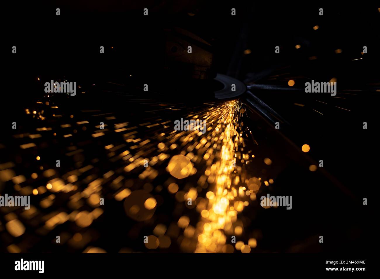 Sparks of yellow color. Metal treatment. Lights in dark. Sparks from ...