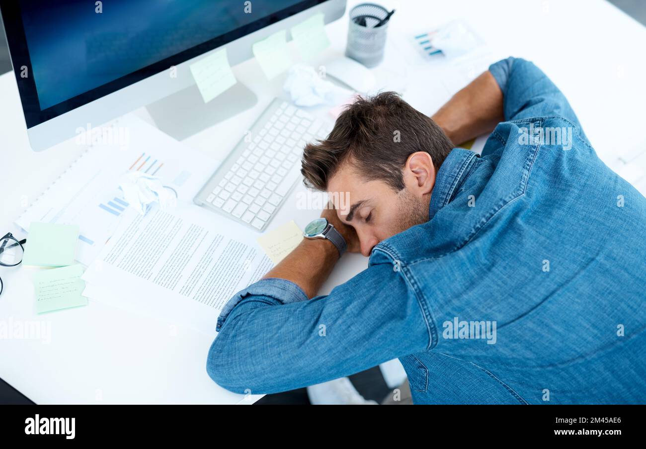 Im just taking a power nap relax. High angle shot of an exhausted young ...