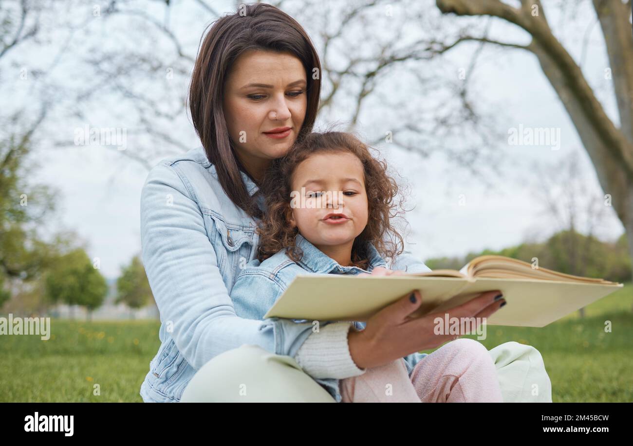 Nature, mother and child reading book in park, story time in park or ...