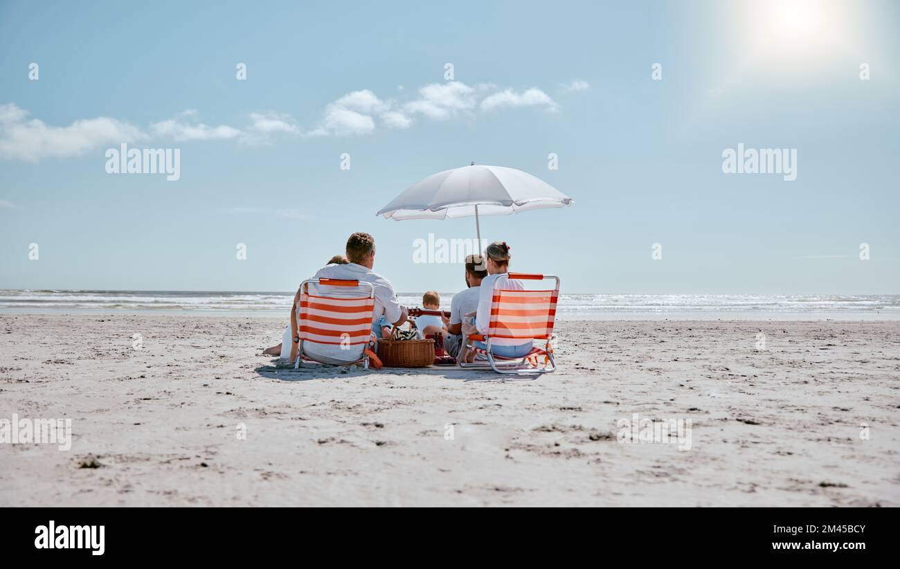 Family, relax and picnic in the sun on the beach for summer vacation ...