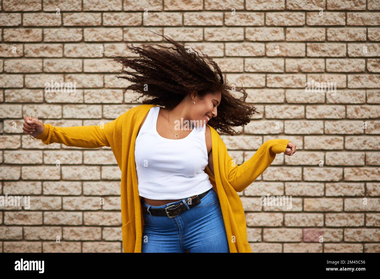 Woman brick wall happy hi-res stock photography and images - Alamy