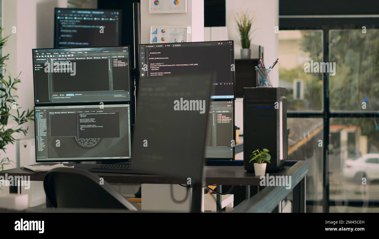 Computer Screens On Desk Running Programming Code Data Algorithms In Empty Coding Room Database