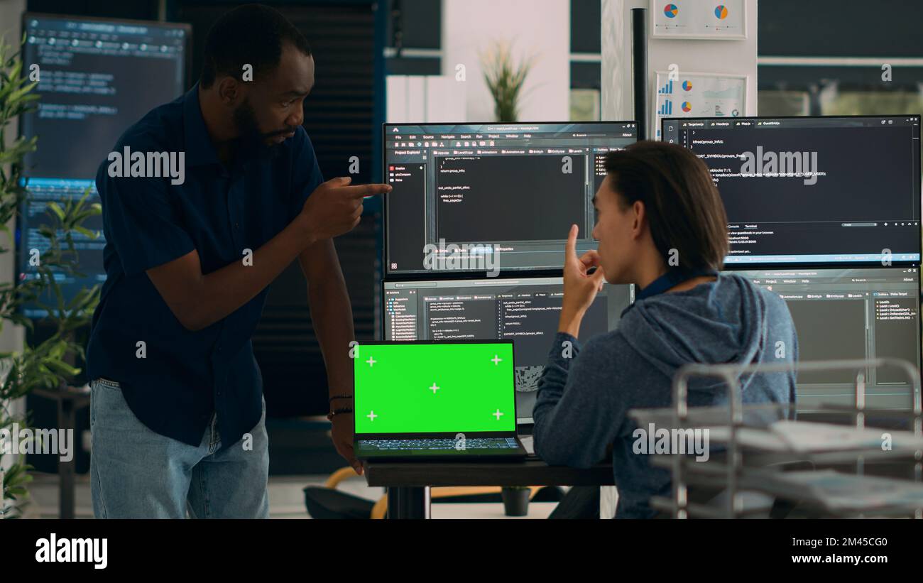 Diverse App Developers Working With Greenscreen On Laptop And