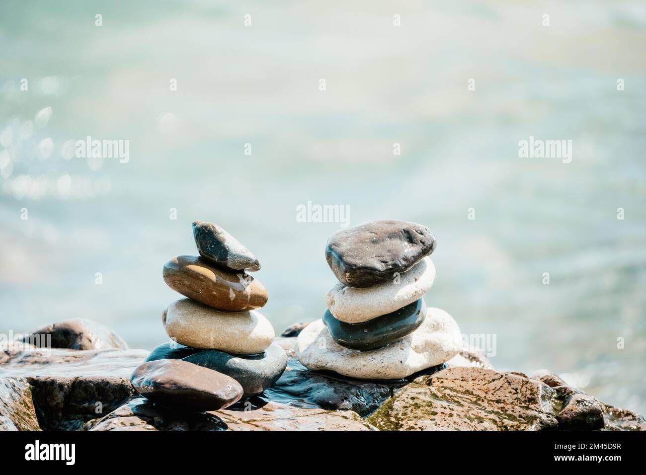 Balanced rock pyramid on pebbles beach, sunny day and clear sky at ...