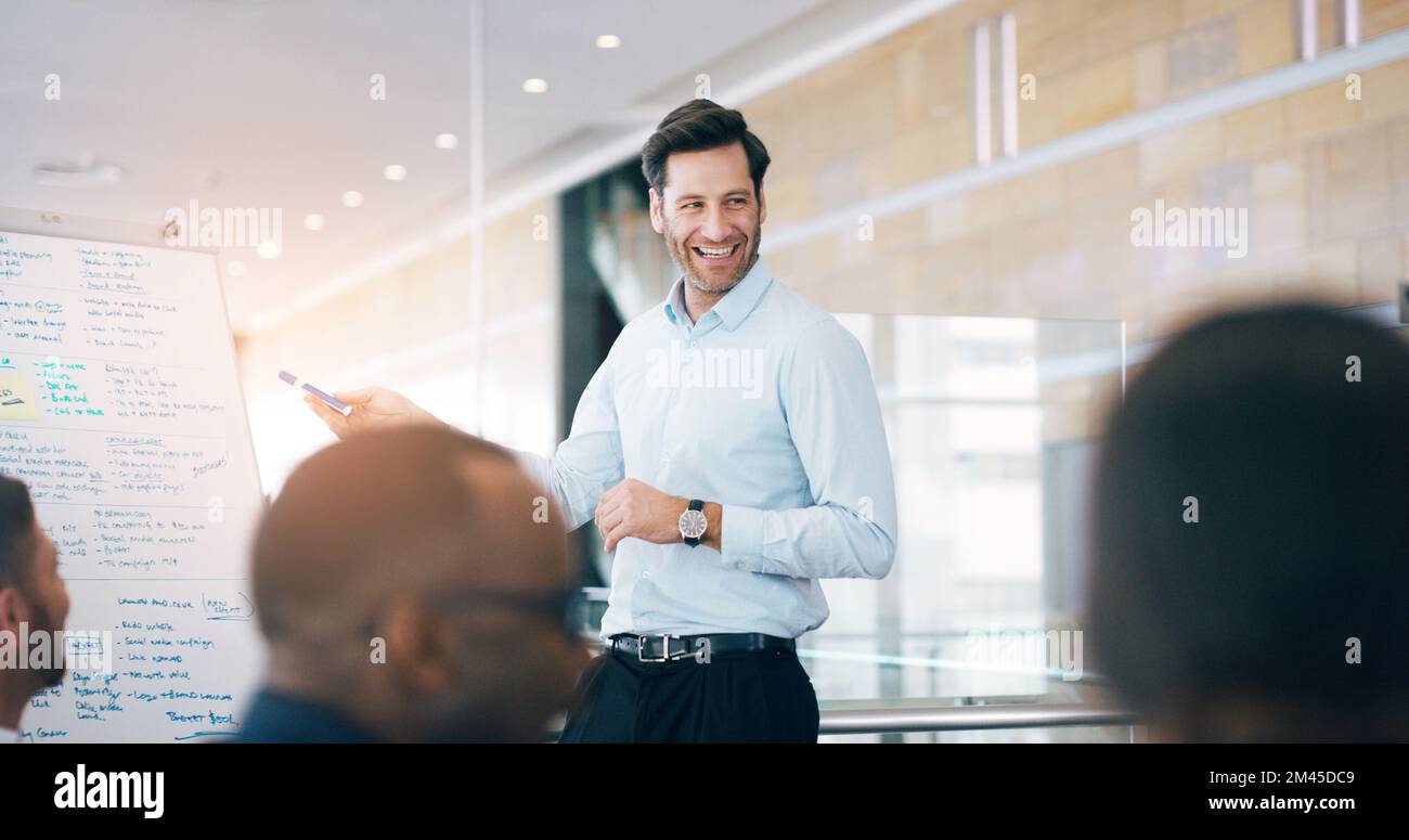 Hes pleased to update them on their progress. a handsome middle aged man giving a presentation ...