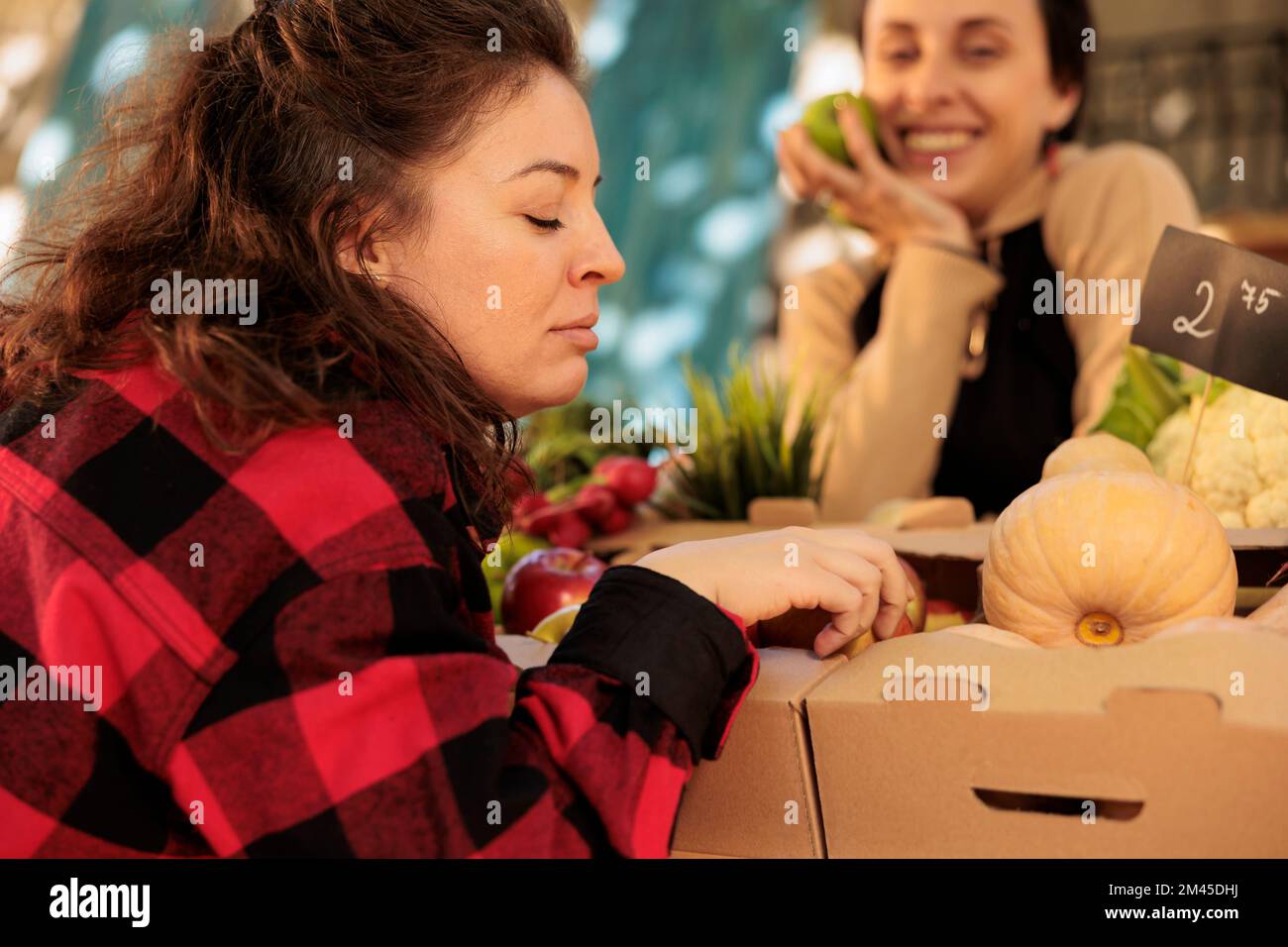 Young woman choosing fruits and vegetables while shopping at local ...