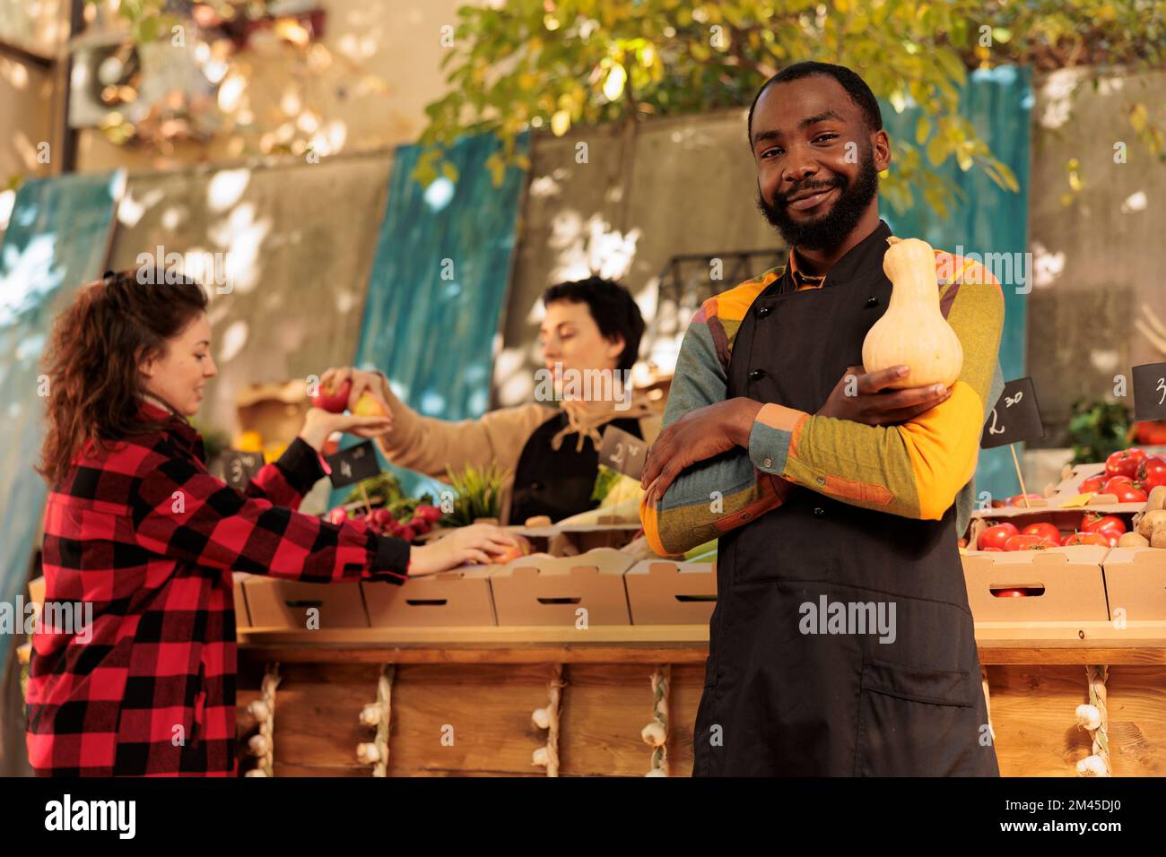 Successful small business owner standing in front of food market ...
