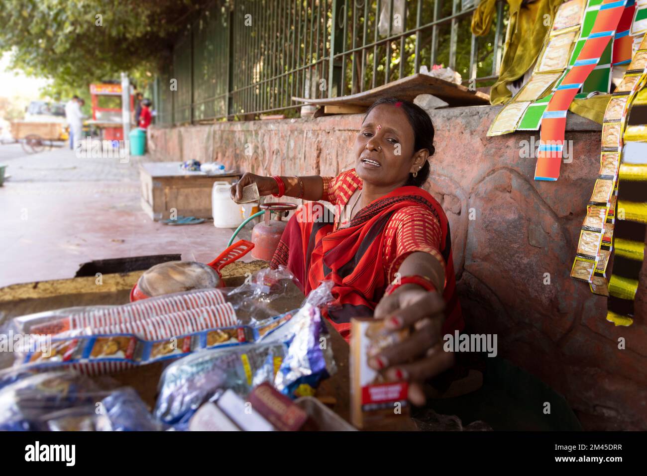 Female vendor selling cigarette at her roadside stall Stock Photo - Alamy