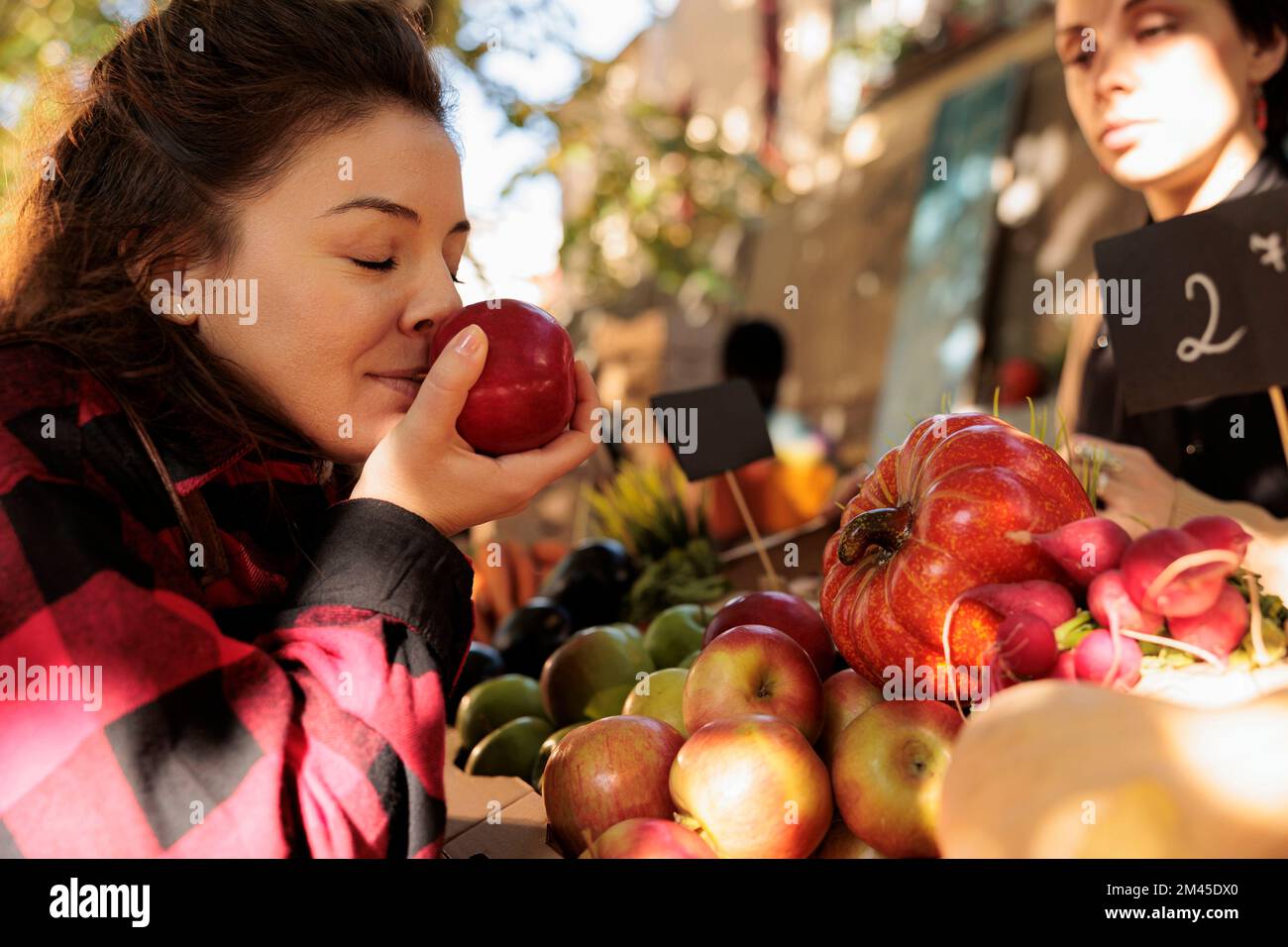 Healthy customer enjoying organic natural smell of apples, standing in ...
