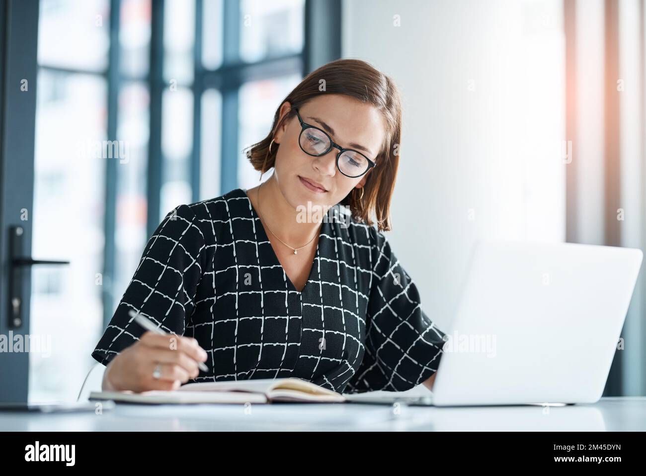 Embracing her work responsibilities. a focused young businesswoman ...