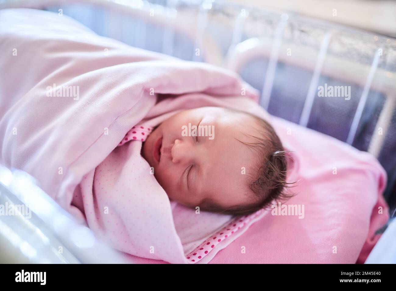 Dont disturb. a newly born baby girl wrapped in a blanket in the ...
