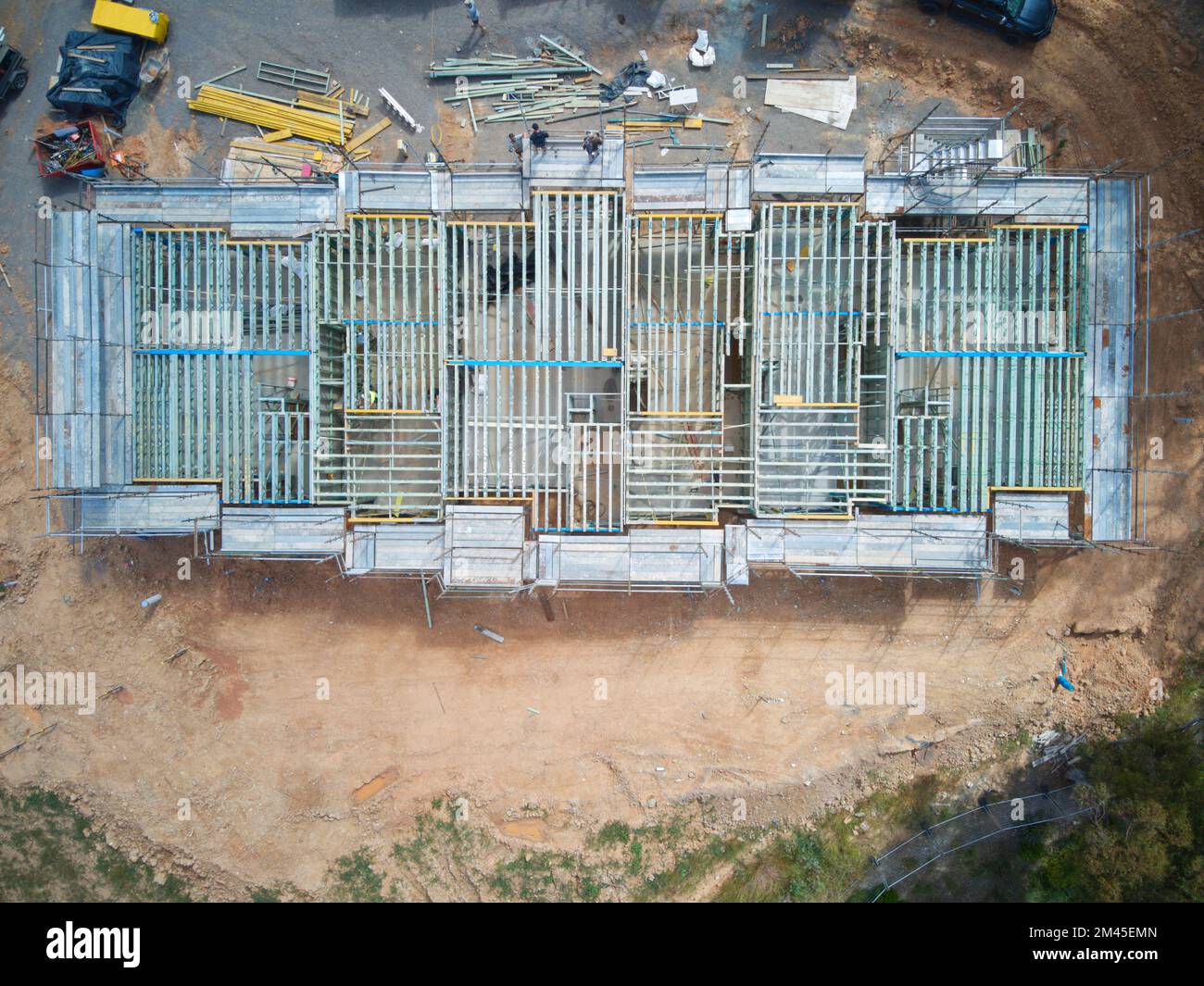 Building construction frame with building site, materials, equipment ...