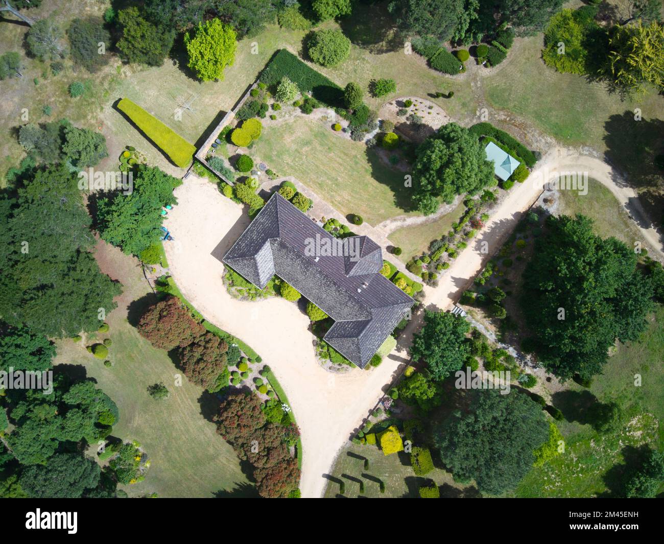 Home from above showing an aerial view of a house set in a green garden ...