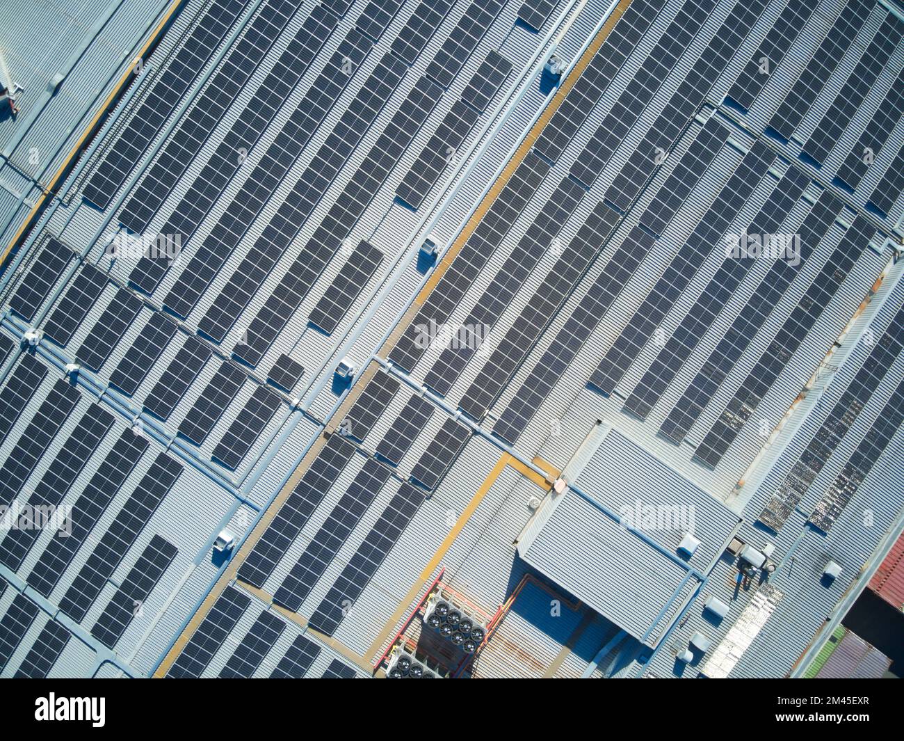 Solar panels on building aerial view showing multiple photovoltaic ...