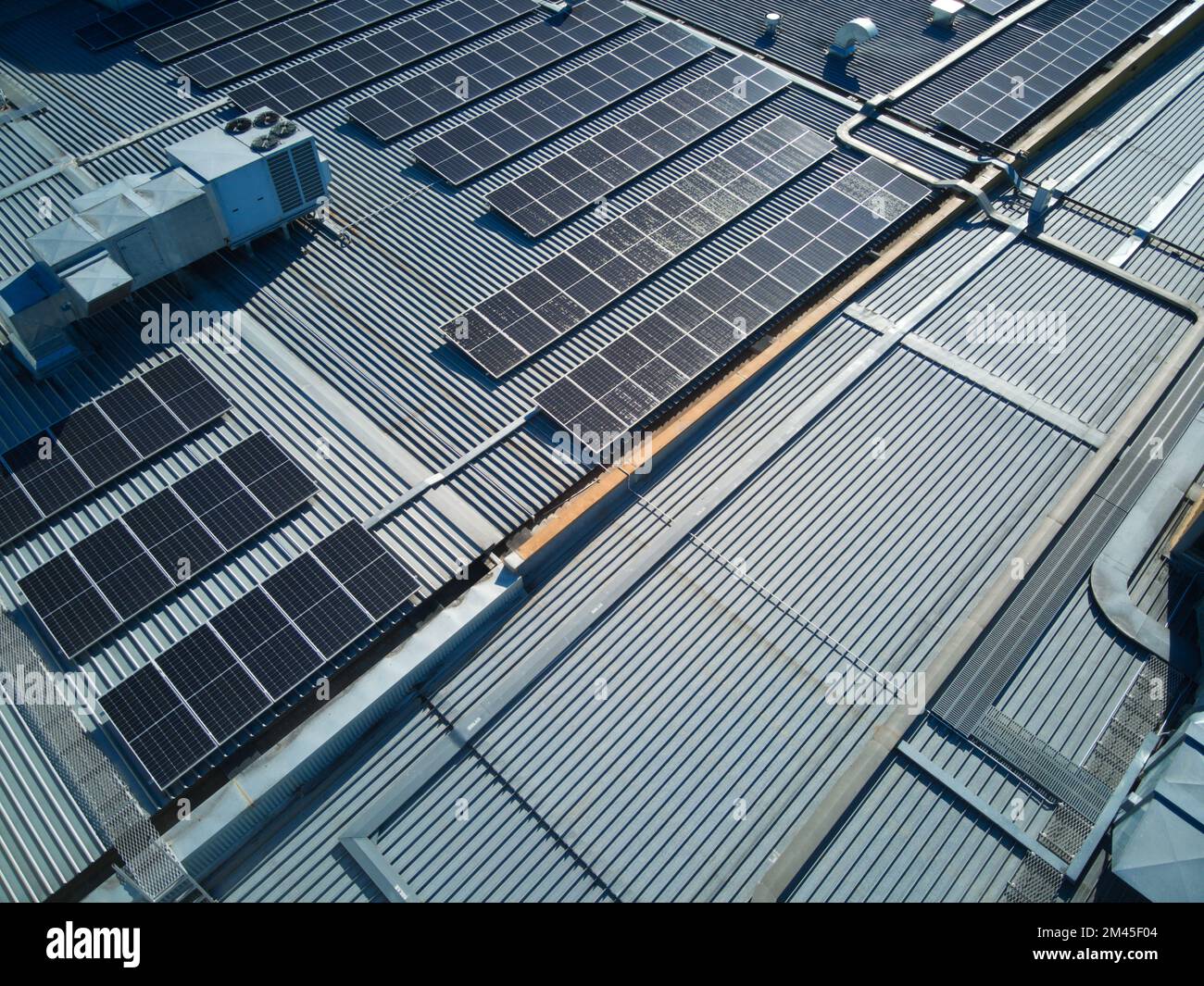 Solar panels on building aerial view showing multiple photovoltaic ...