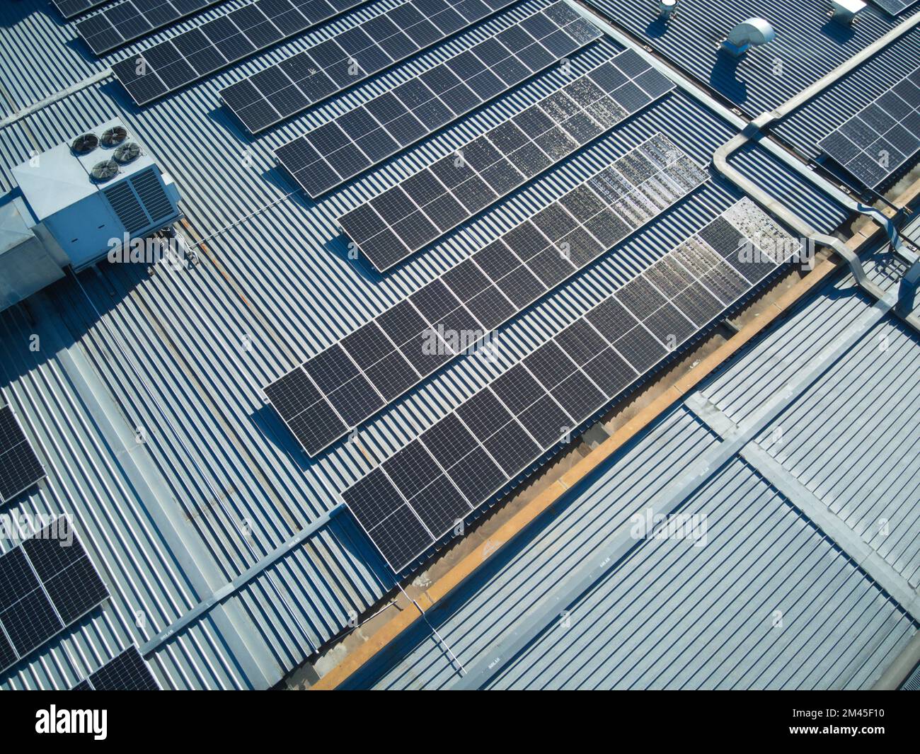 Solar panels on building aerial view showing multiple photovoltaic ...