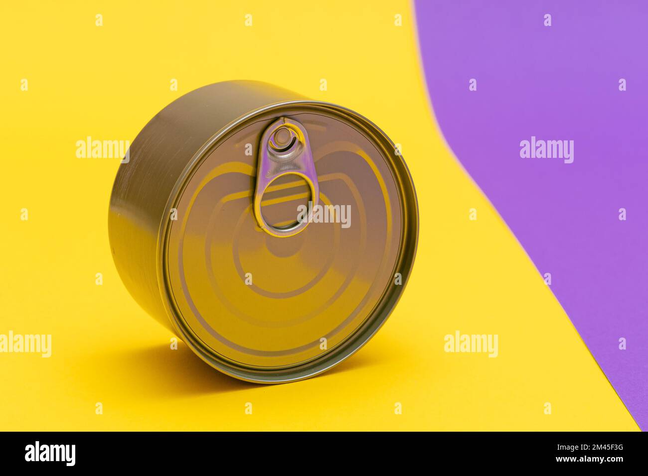 Unopened Tin Can with Blank Edge on Split Yellow and Violet Background ...