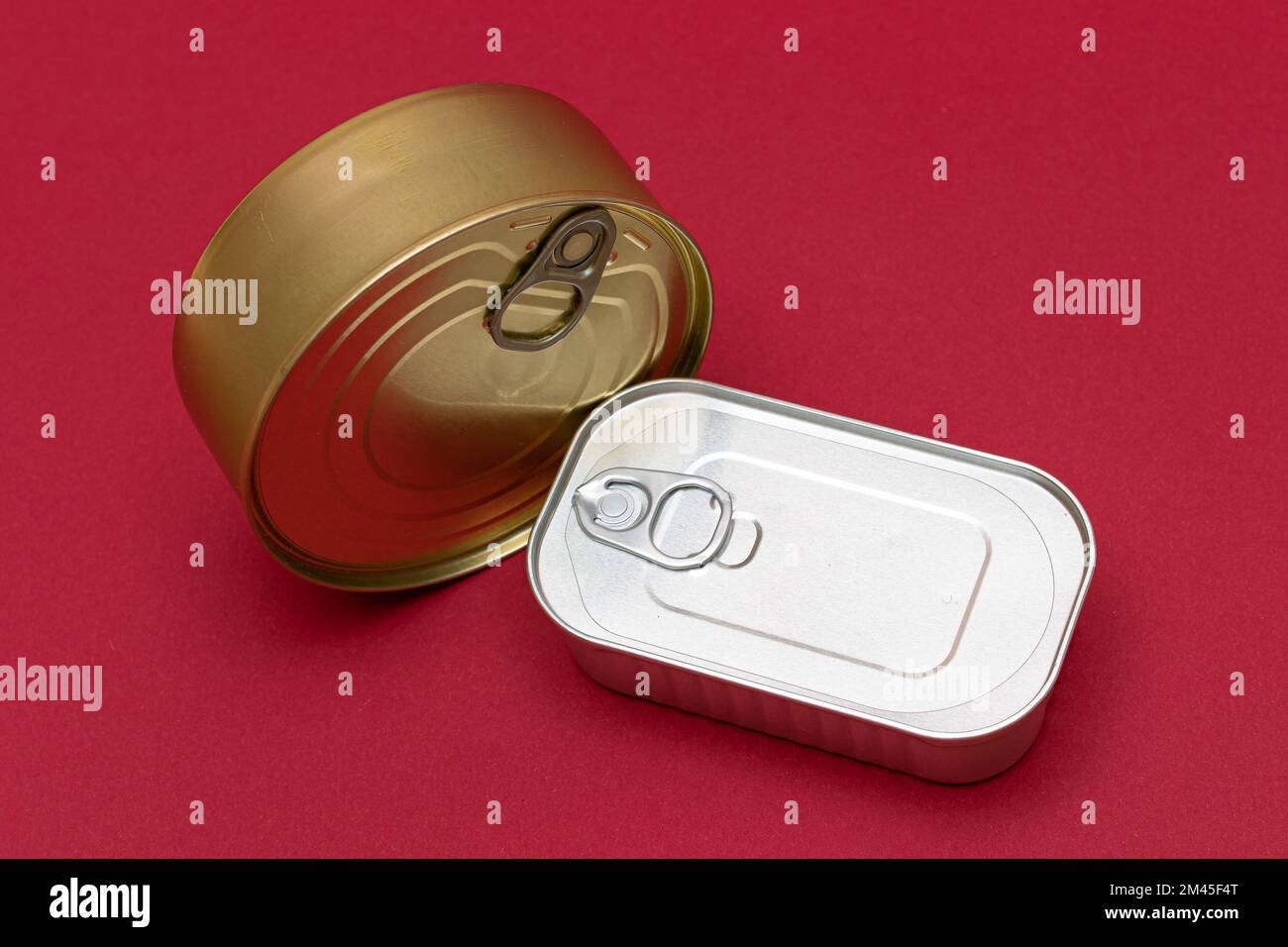 A Group of Stacked Tin Cans with Blank Edges on Red Background. Canned ...