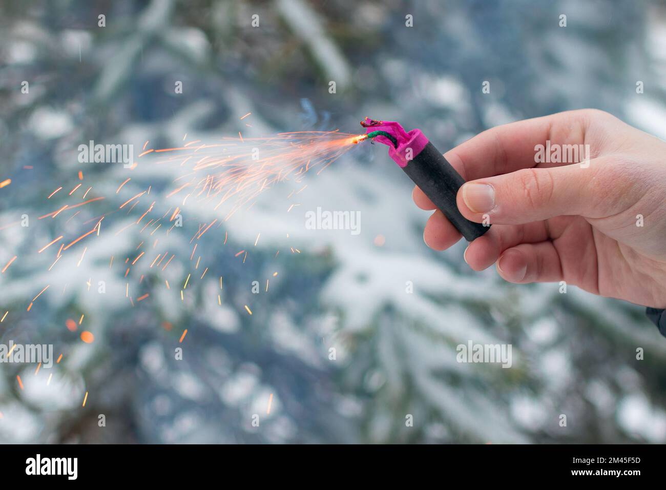 Burning Firecracker in a Hand. Guy Holding a Petard Outdoors in Winter ...