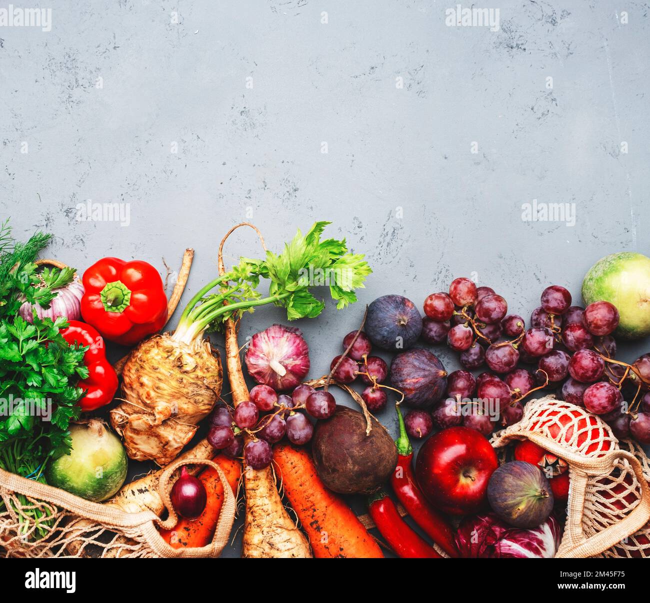 Food background with vegetables, root crops and fruits in string bag ...