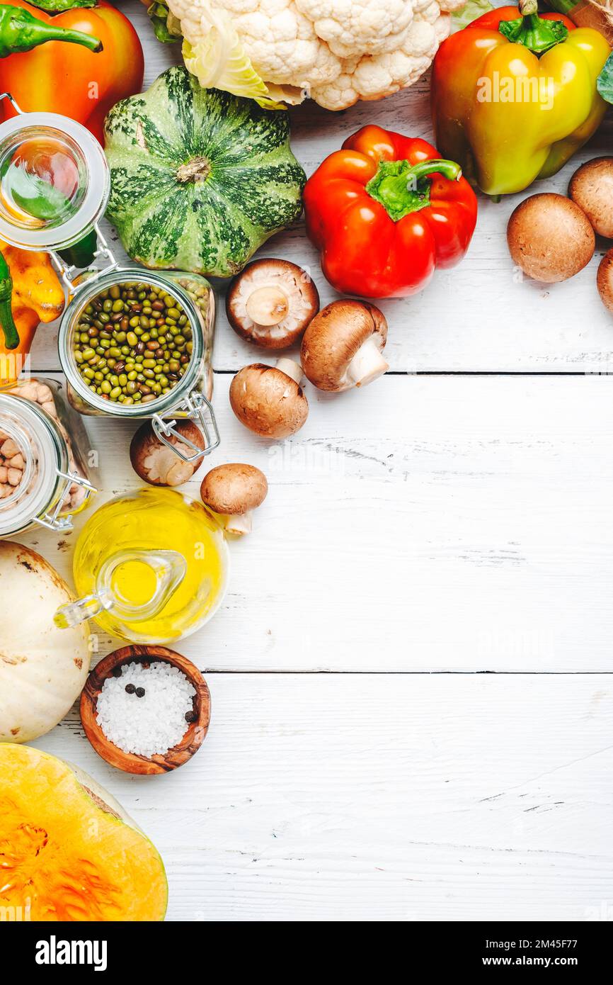 Food background with vegetarian cooking ingredients. Organic vegetables ...