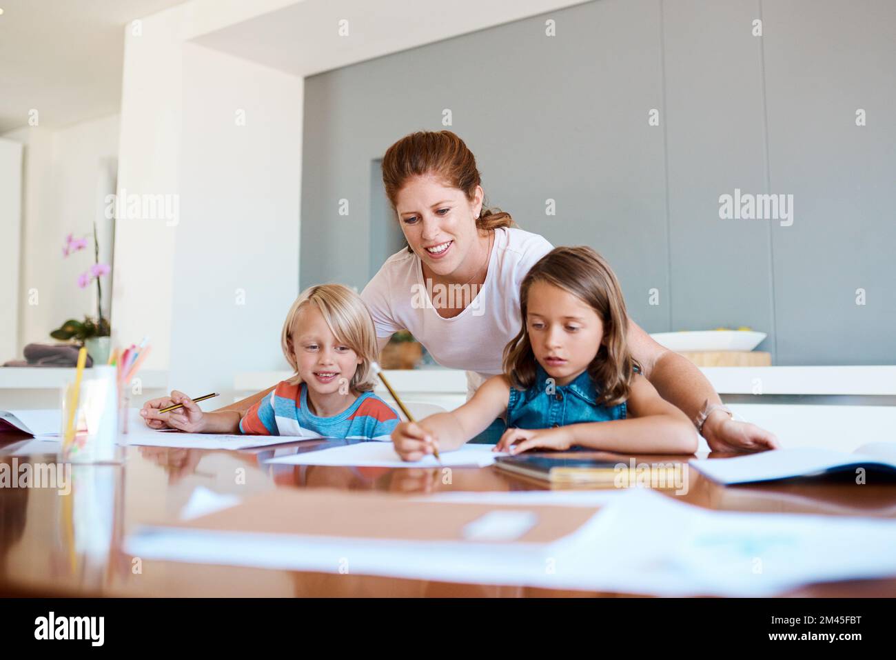 Shaping these little minds for a big future. a young mother helping her ...