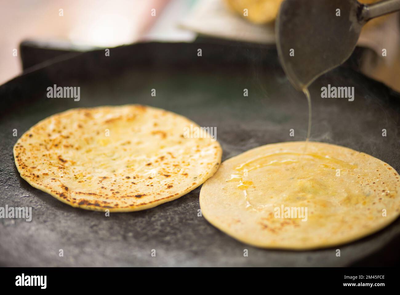 Closeup portrait of paratha preparing with ghee Stock Photo - Alamy
