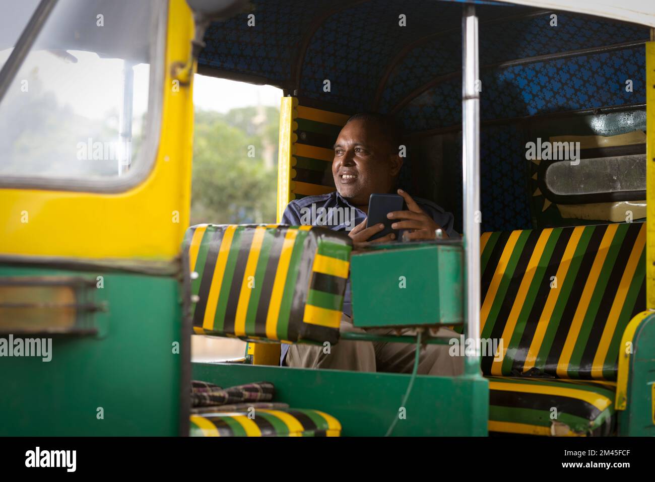 Auto rickshaw using mobile hi-res stock photography and images - Alamy