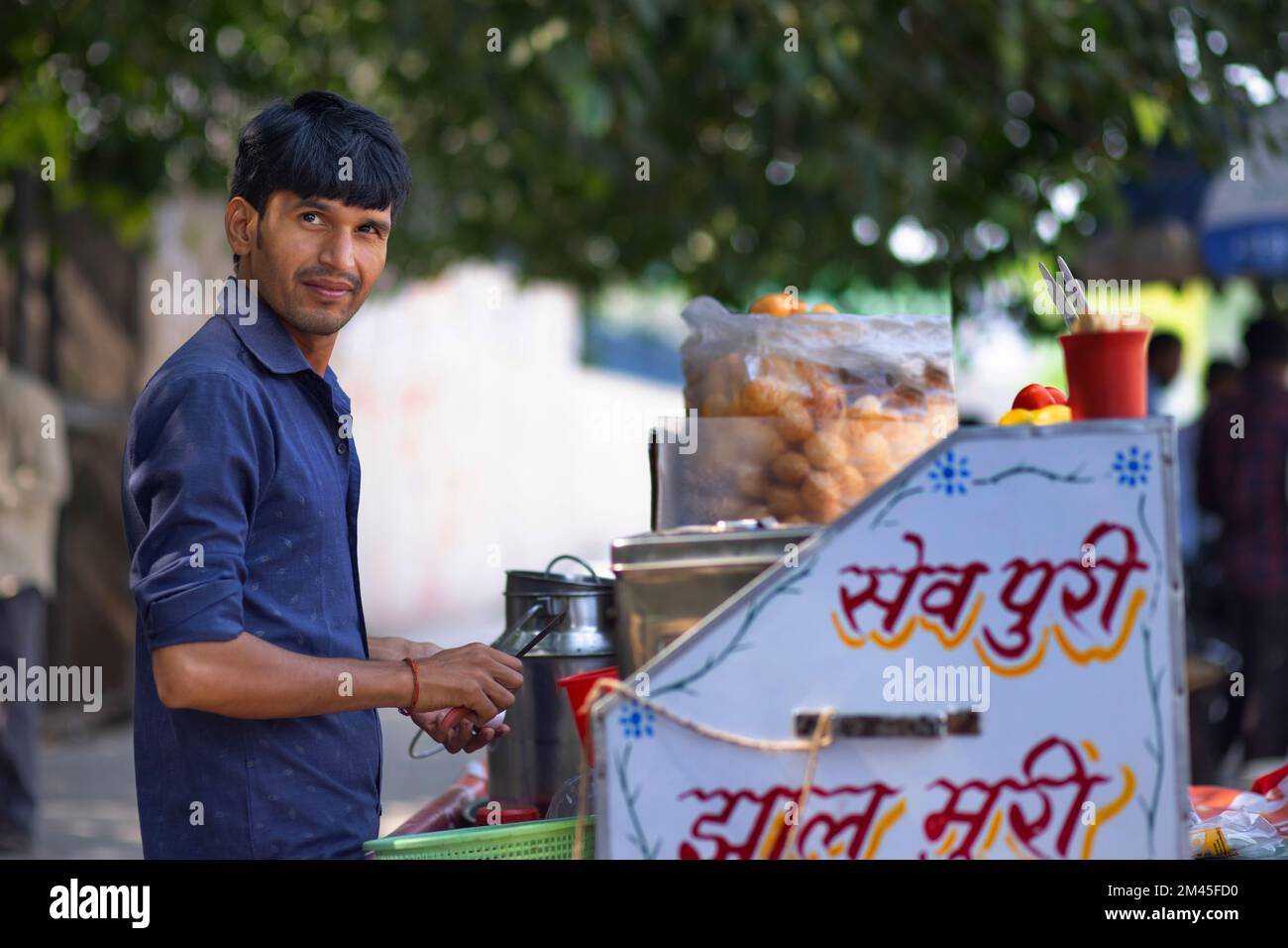 Portrait of a male street vendor looking elsewhere Stock Photo - Alamy