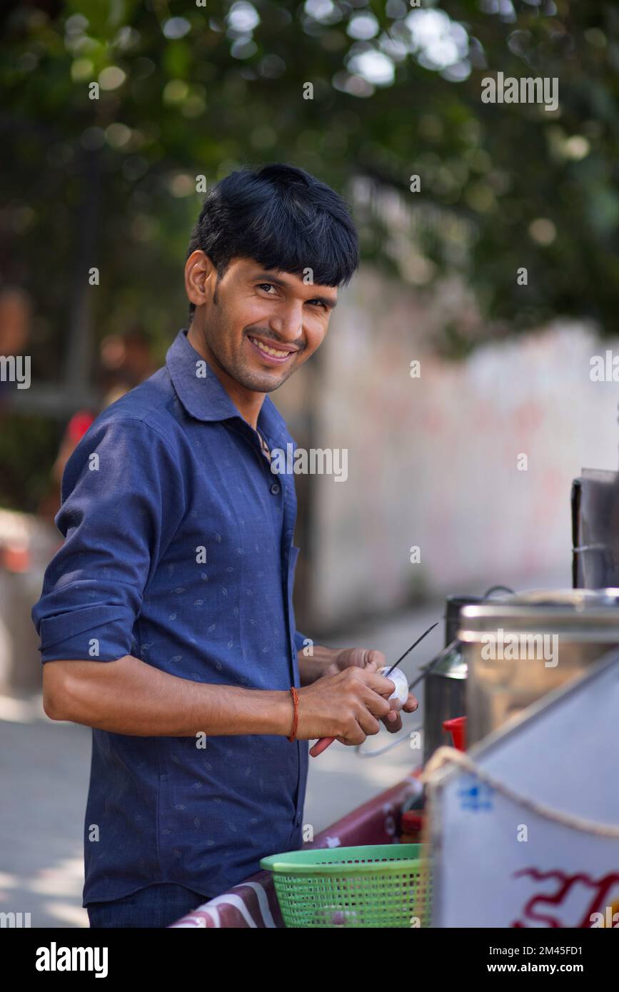 Portrait of a male street vendor looking at camera Stock Photo - Alamy
