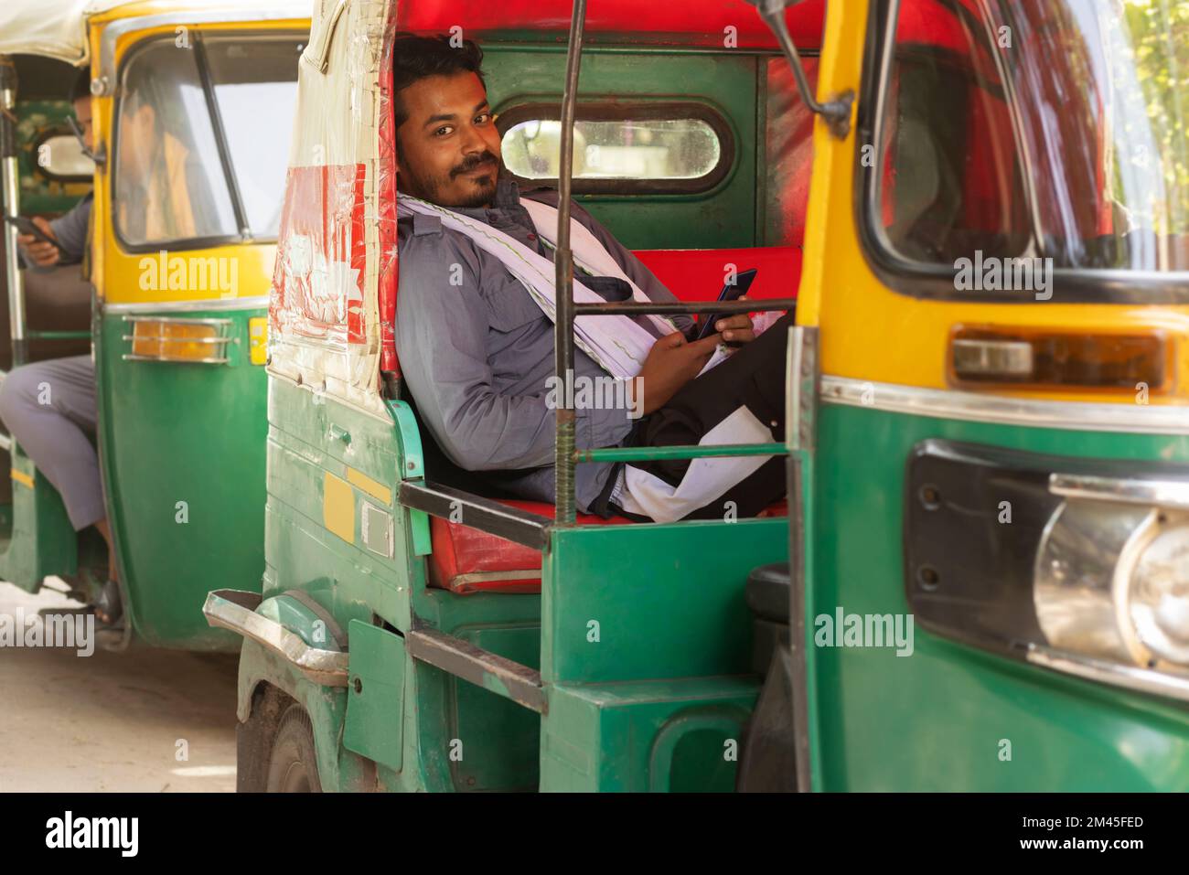 Auto rickshaw using mobile hi-res stock photography and images - Alamy