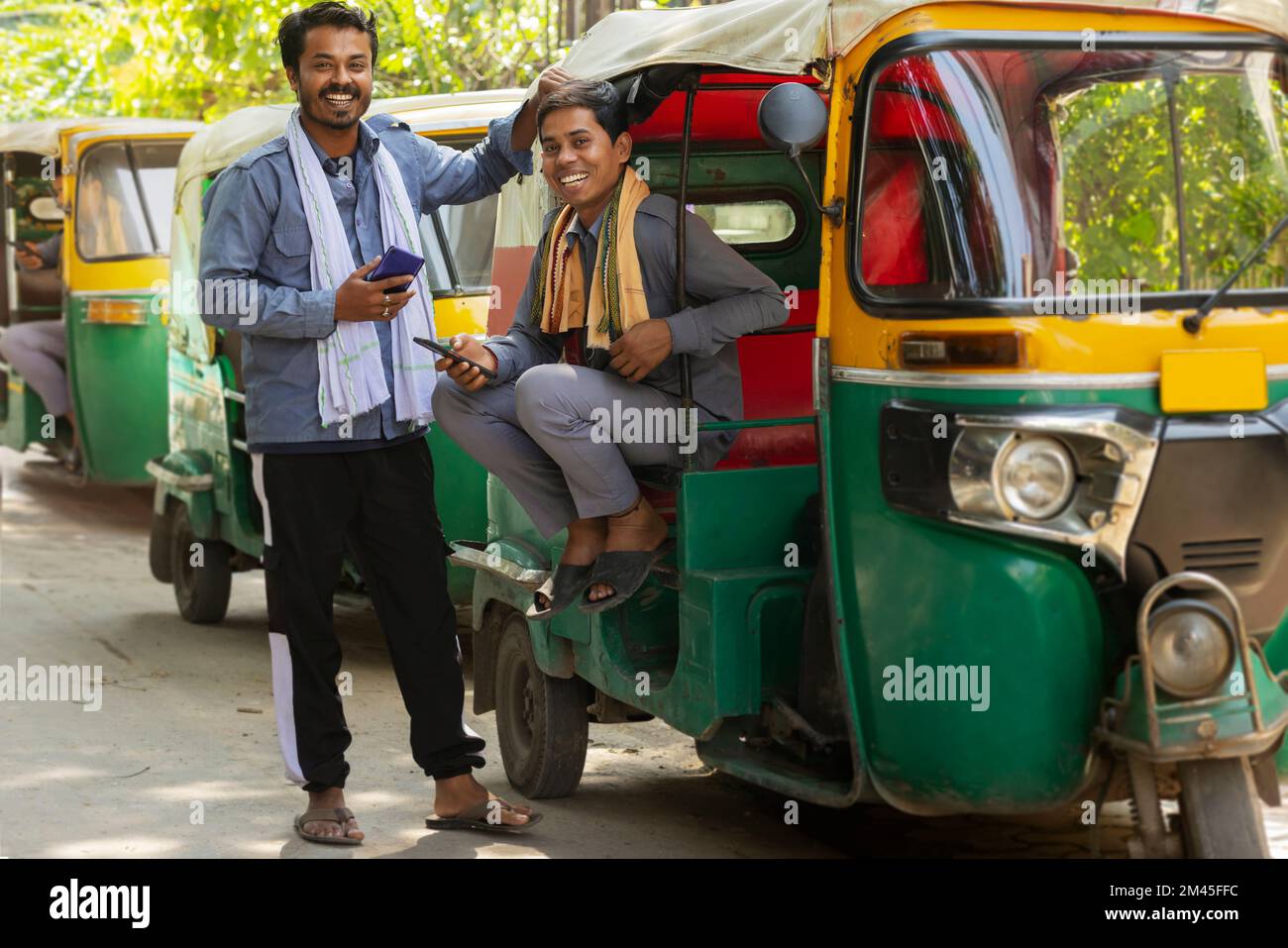 Auto rickshaw drivers using their mobile phones at auto stand Stock ...