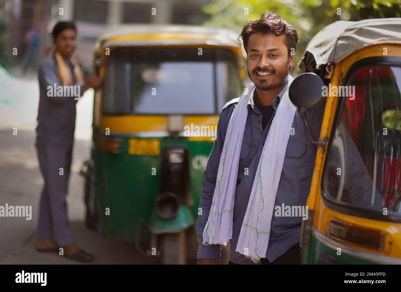 Portrait of happy auto rickshaw driver standing at auto stand Stock ...