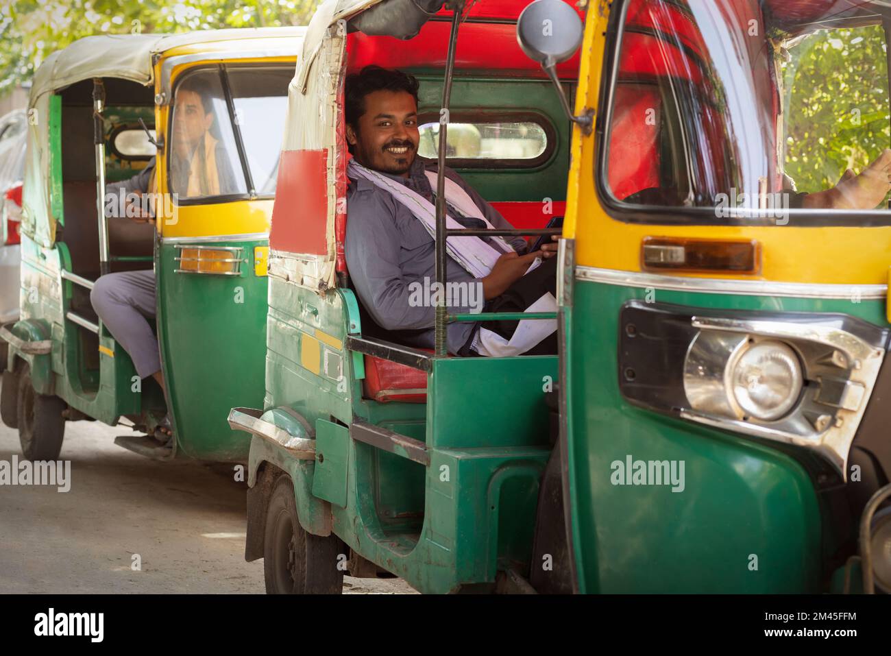 Auto rickshaw using mobile hi-res stock photography and images - Alamy