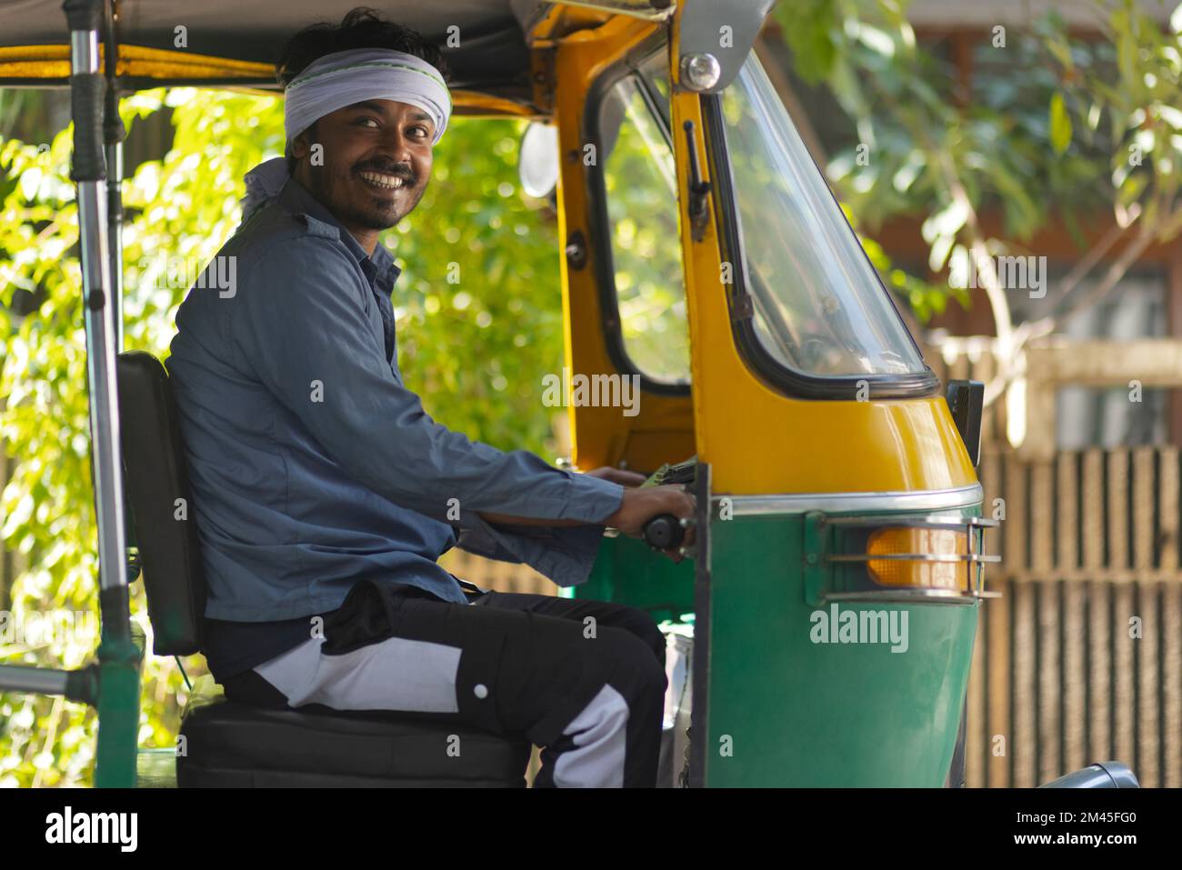 Portrait of a happy young man driving auto rickshaw Stock Photo - Alamy