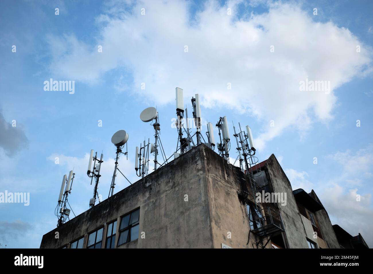 Multiple mobile transmission towers affixed on a stationary building ...