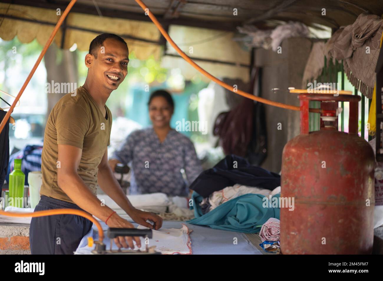 Smiling Man, dhobi ironing clothing outside using a gas cylinder Stock ...