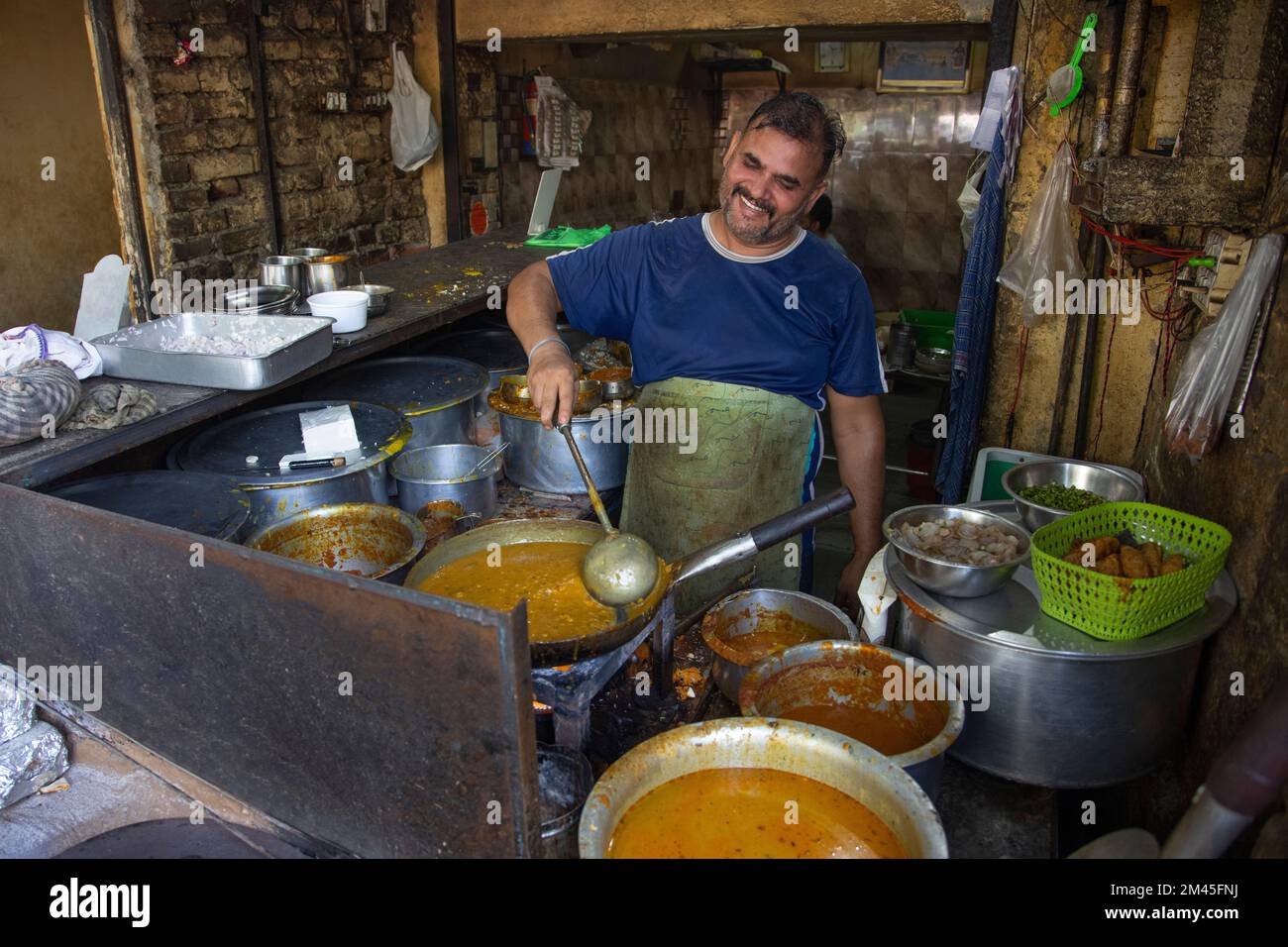A cook and an owner of a local roadside restaurant or a dhaba, cooking ...