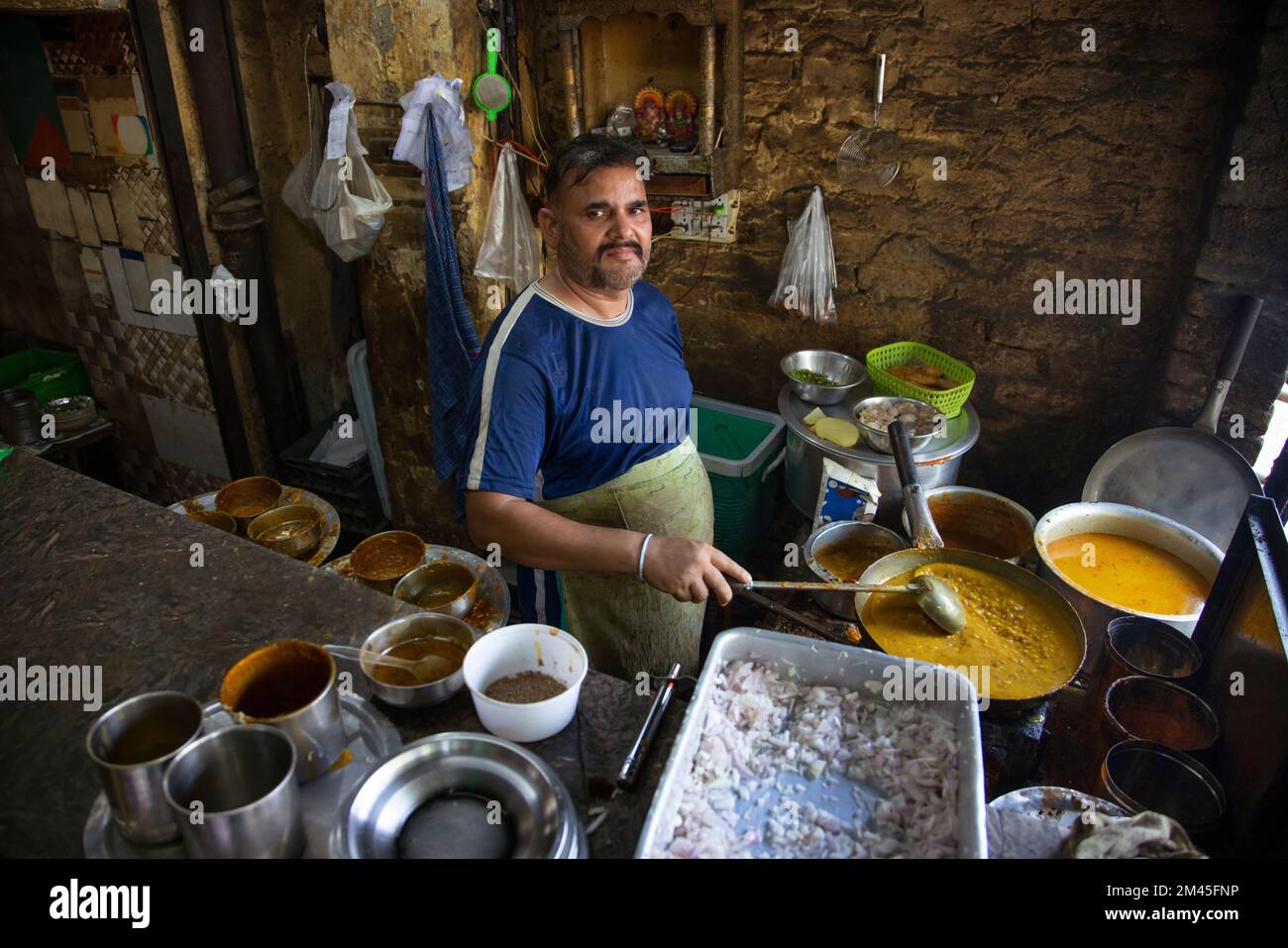 A cook and an owner of a local roadside restaurant or a dhaba, cooking ...