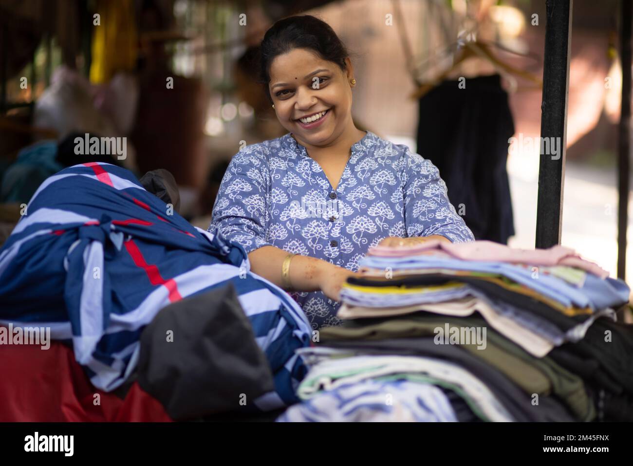 Woman folding clothes table hi-res stock photography and images - Alamy