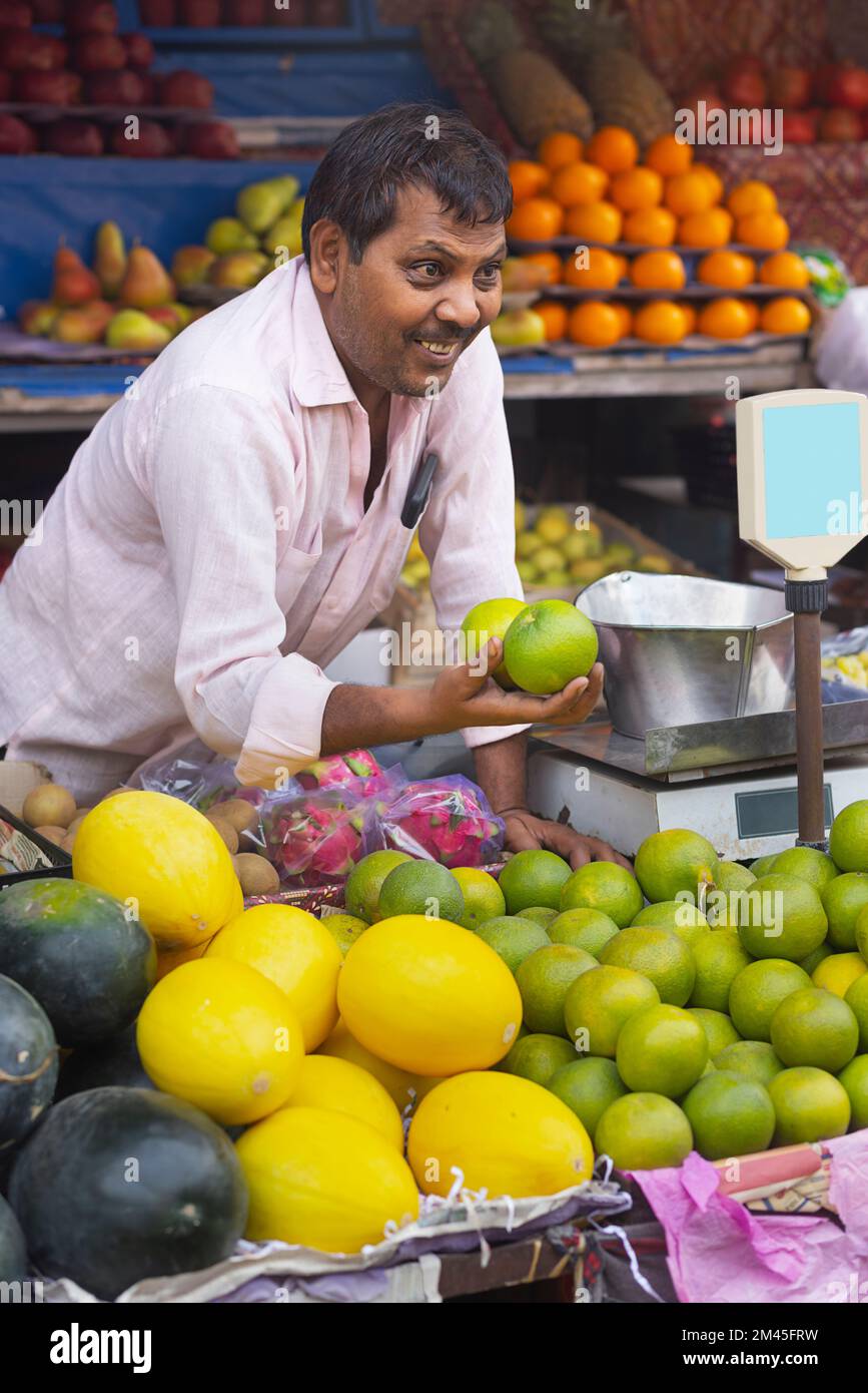 Fruit vendour Selling Fruits at the Market Stock Photo - Alamy