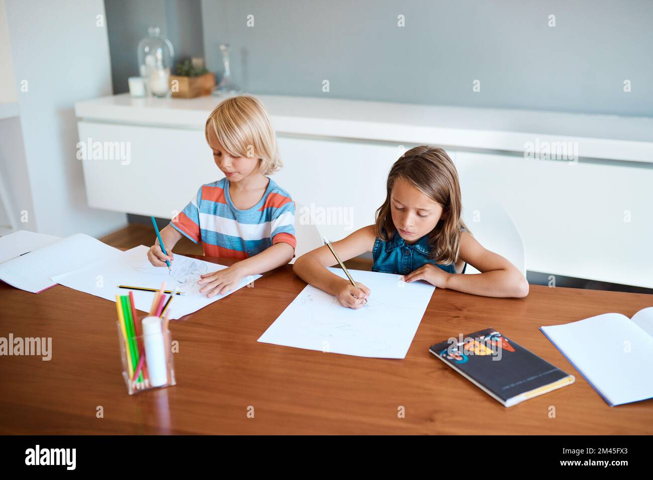 Creativity is born within them. two adorable young children doing their ...