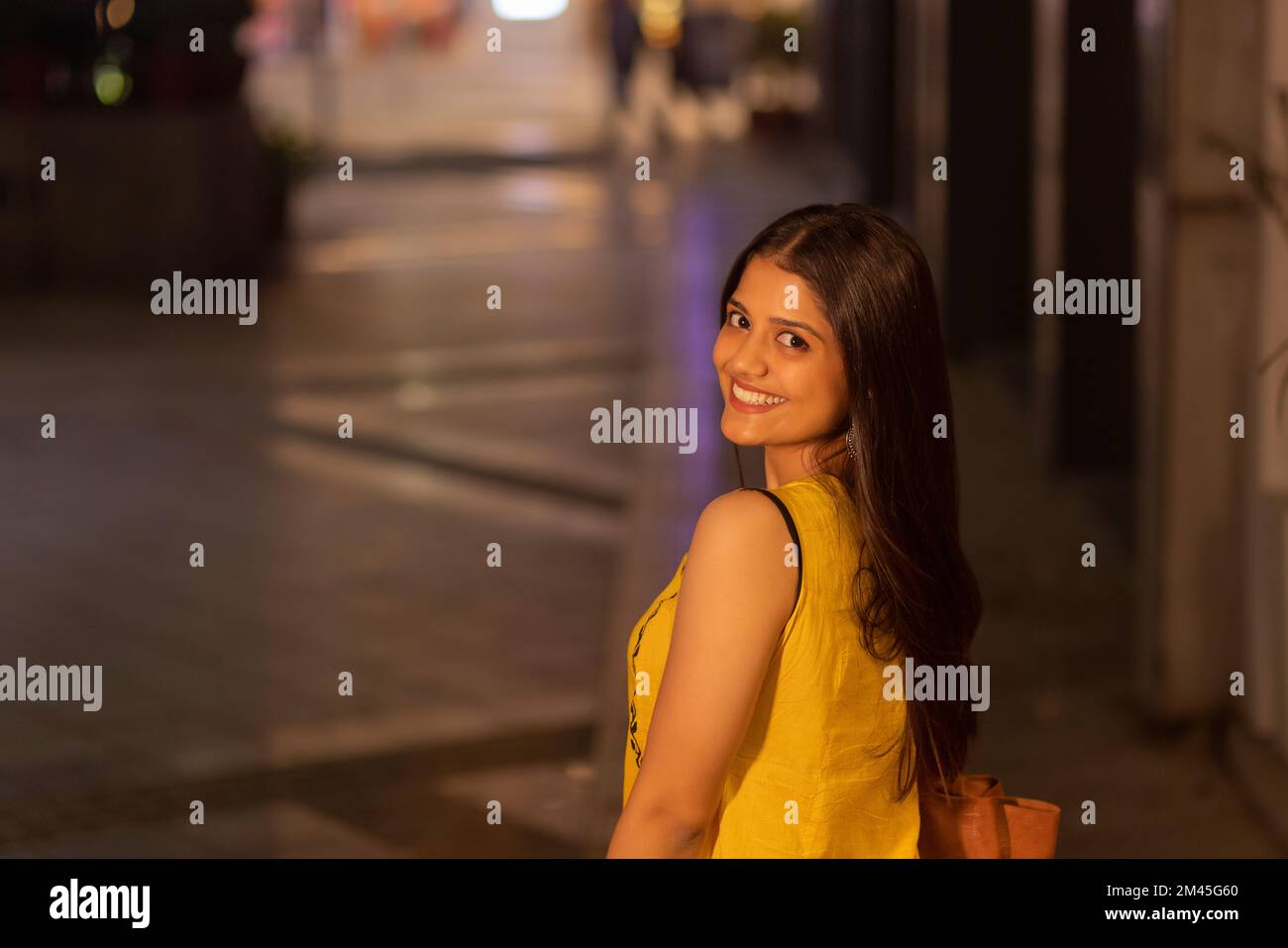 Woman looking back at camera hi-res stock photography and images - Alamy