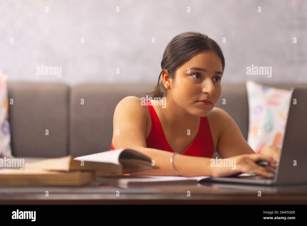 Portrait of a teenage girl doing homework during online classes Stock ...