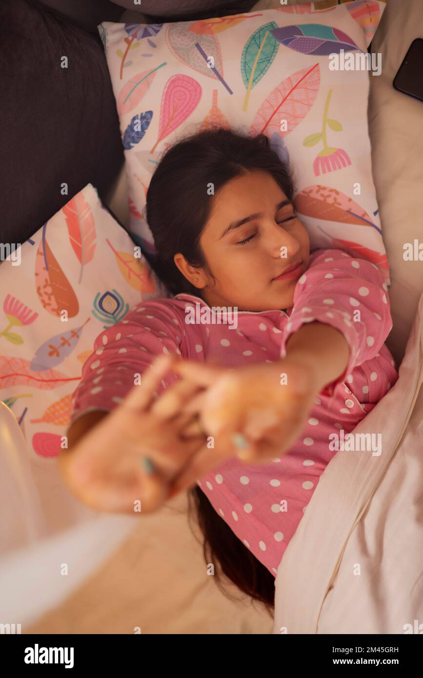Beautiful teenage girl waking up after night sleep Stock Photo - Alamy