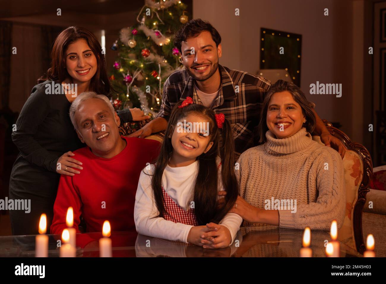 Happy family celebrating Christmas together in living room Stock Photo ...