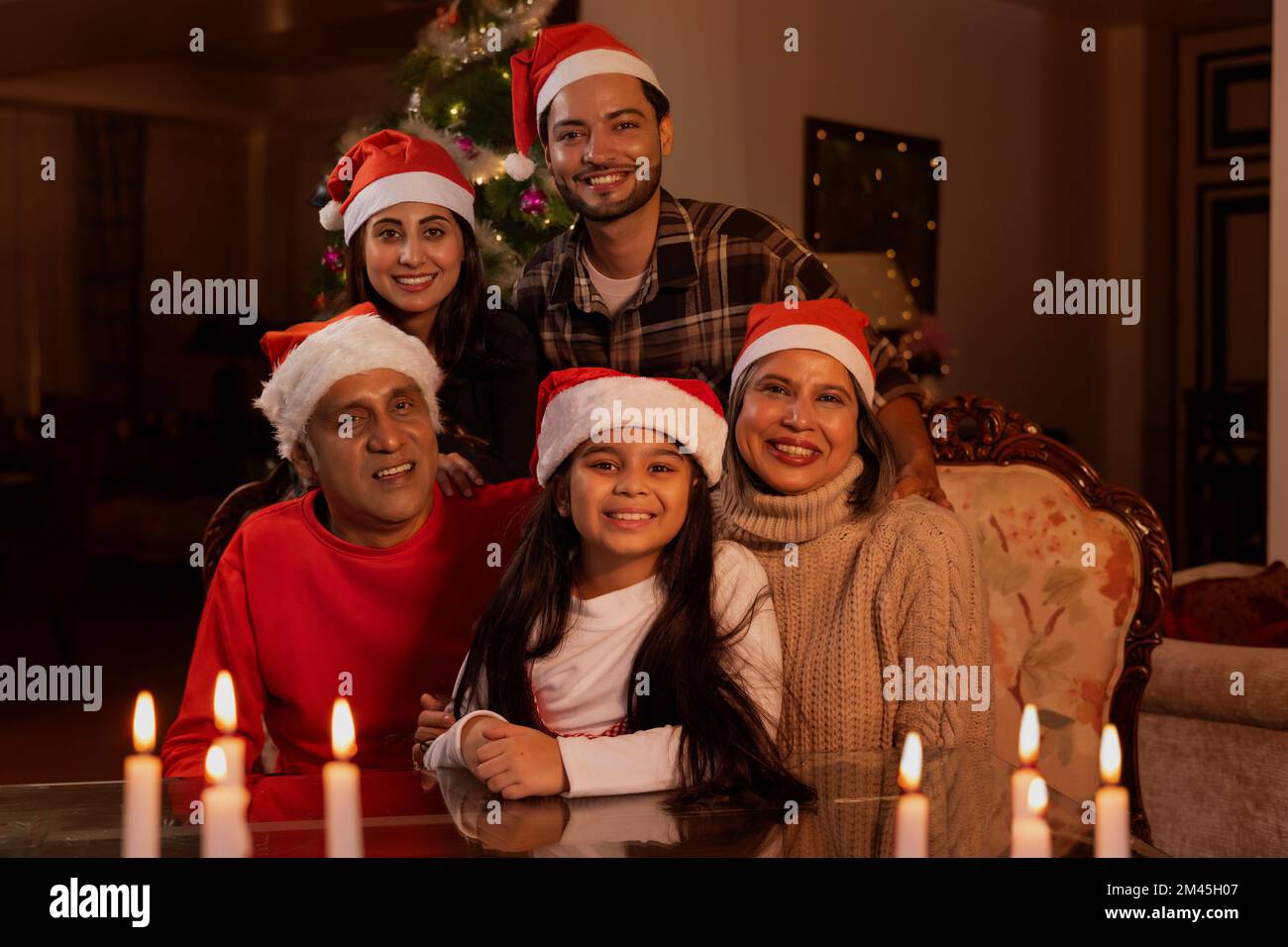 Happy family with Santa hat celebrating Christmas together in living ...