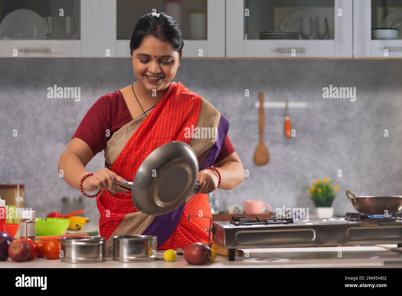 Young woman packing lunch box in kitchen Stock Photo - Alamy